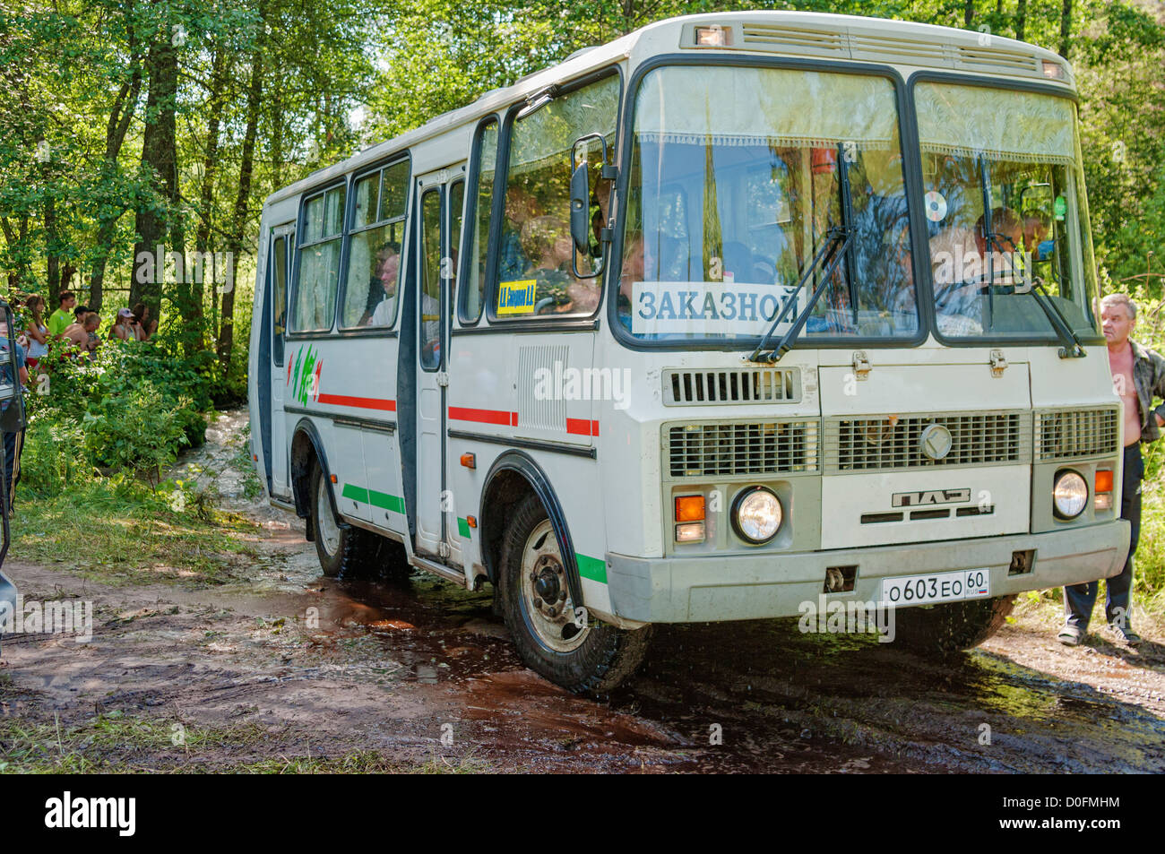 Bus on forest road after fording Stock Photo - Alamy