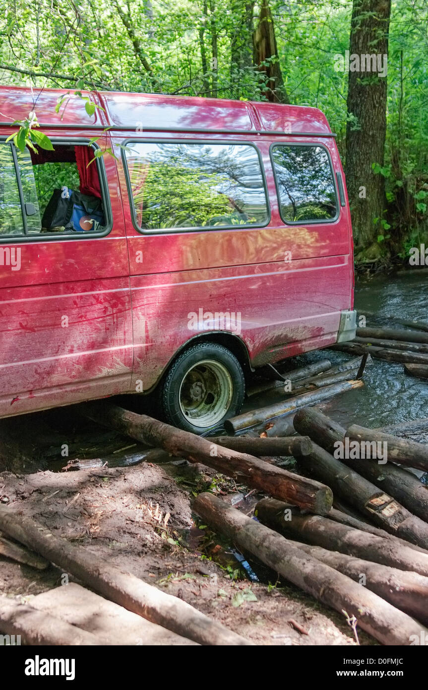 Minibus on broken wooden bridge Stock Photo - Alamy