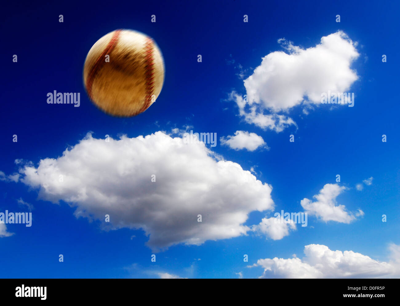 Baseball flying through the air with clouds and sky in background Stock ...