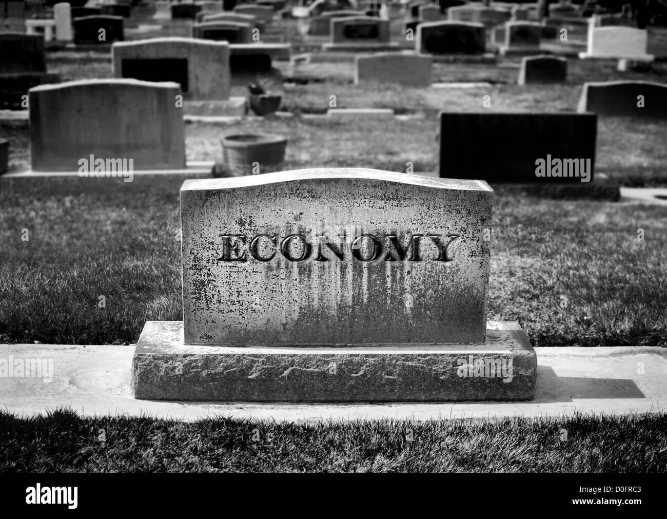Graveyard and headstone or grave stone with economy carved as the name ...