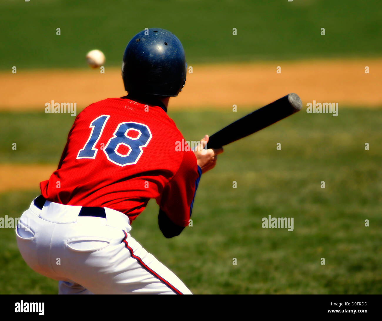 Baseball player wearing uniform bunting a baseball while at bat Stock ...
