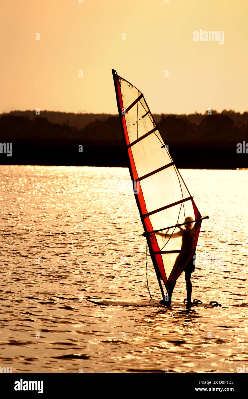 Silhouette of a windserfing sail in the sunset Stock Photo - Alamy