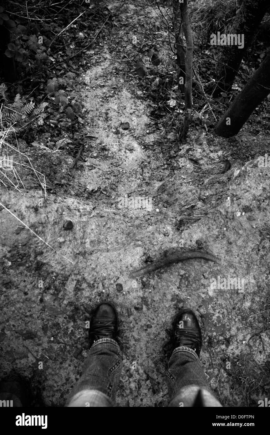 View of boots in mud from above Stock Photo - Alamy