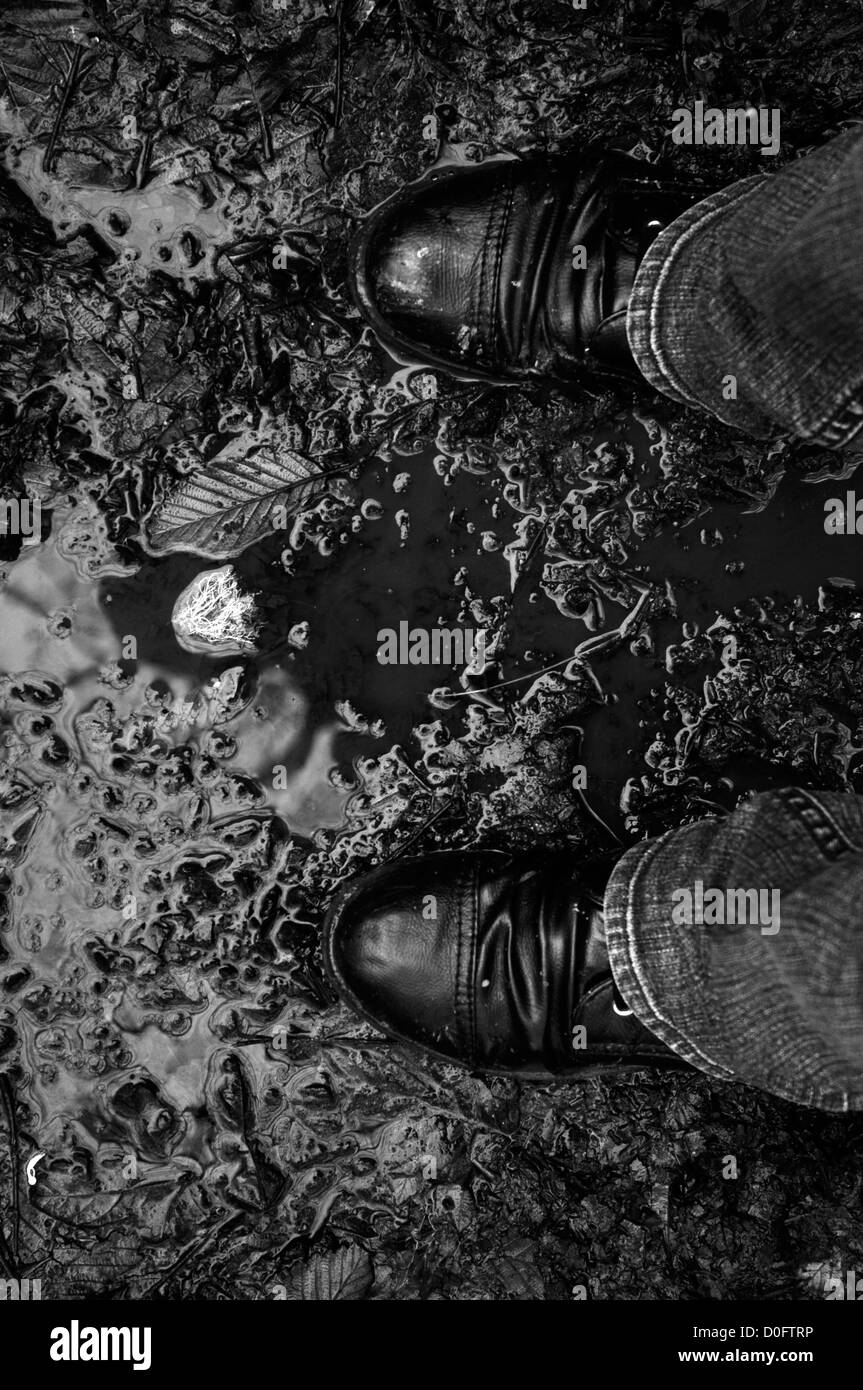 View of boots in mud from above Stock Photo - Alamy