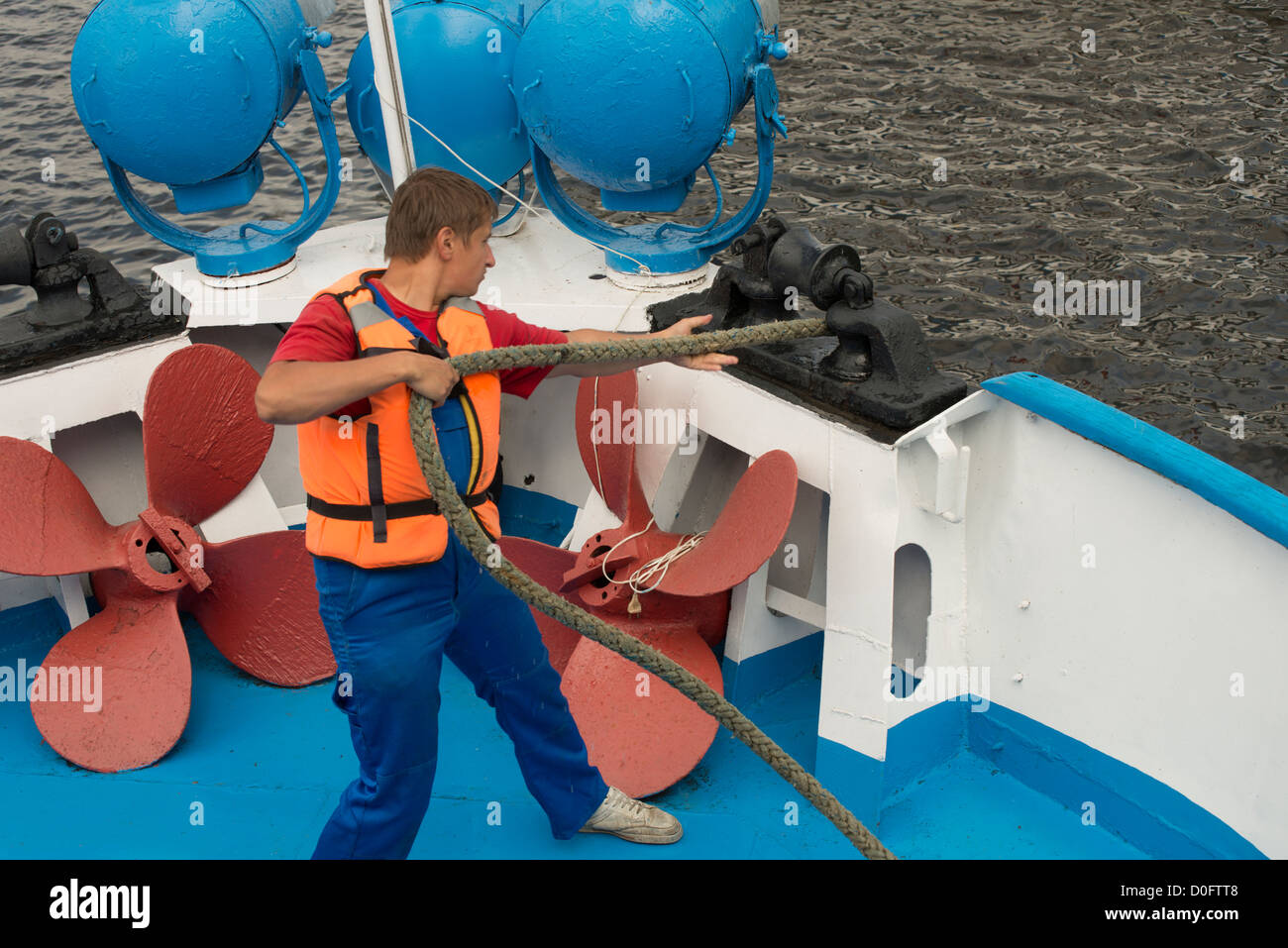 The ship worker prepares a vessel for departure. Taken in Russia, Volga ...