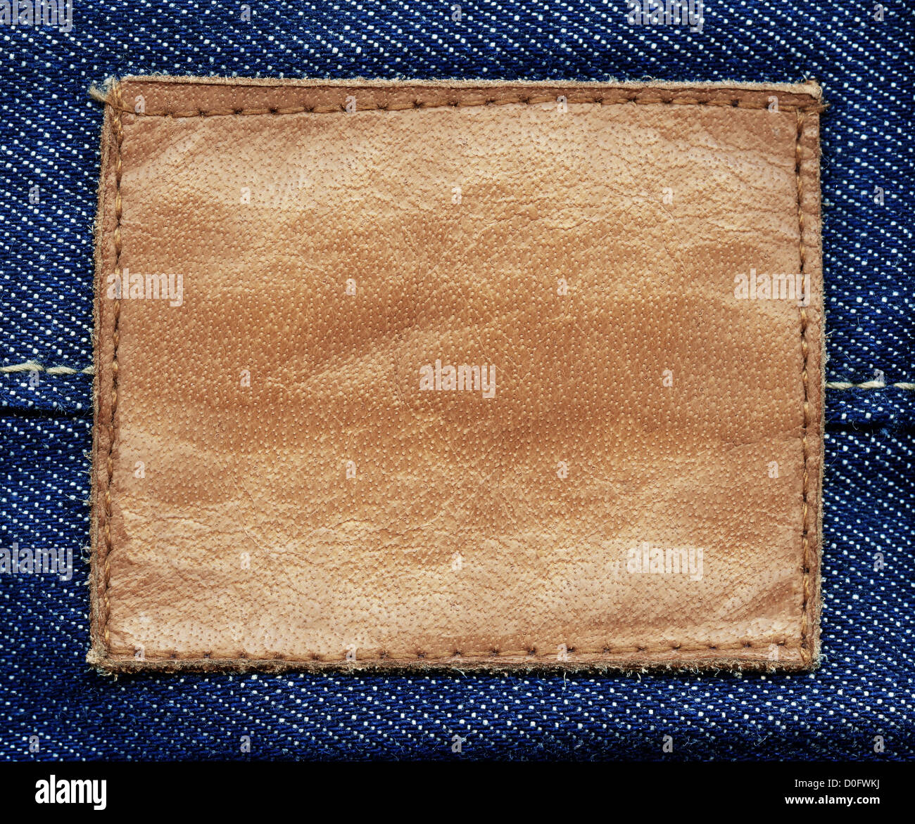 Leather jeans label sewed on jeans Stock Photo - Alamy