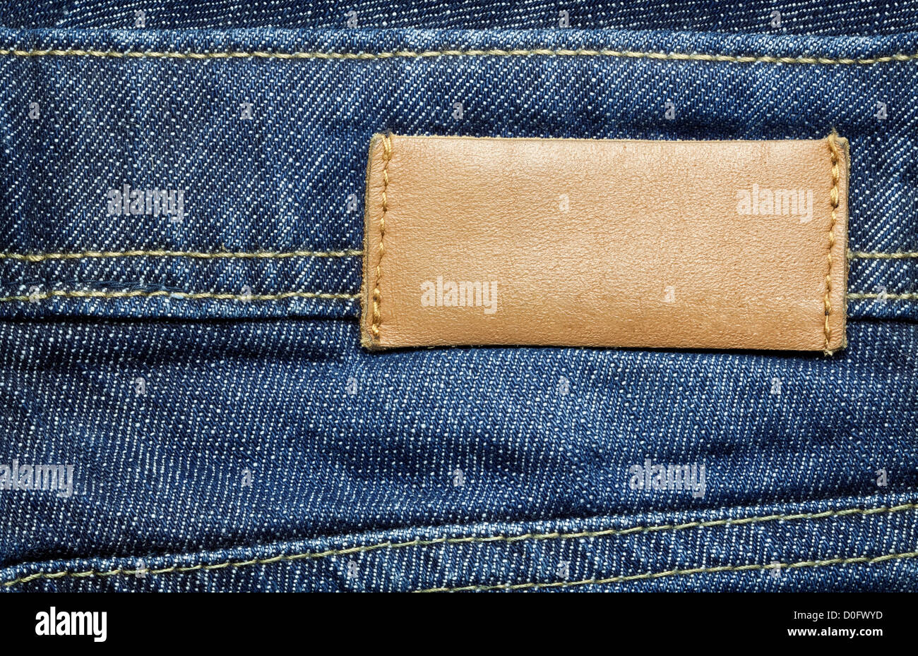 Leather jeans label sewed on jeans Stock Photo - Alamy