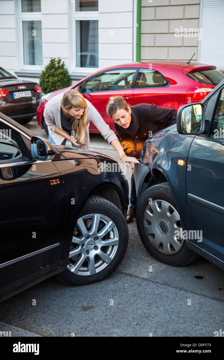 Car accident with minor damage. To woman discus the reason of the car ...
