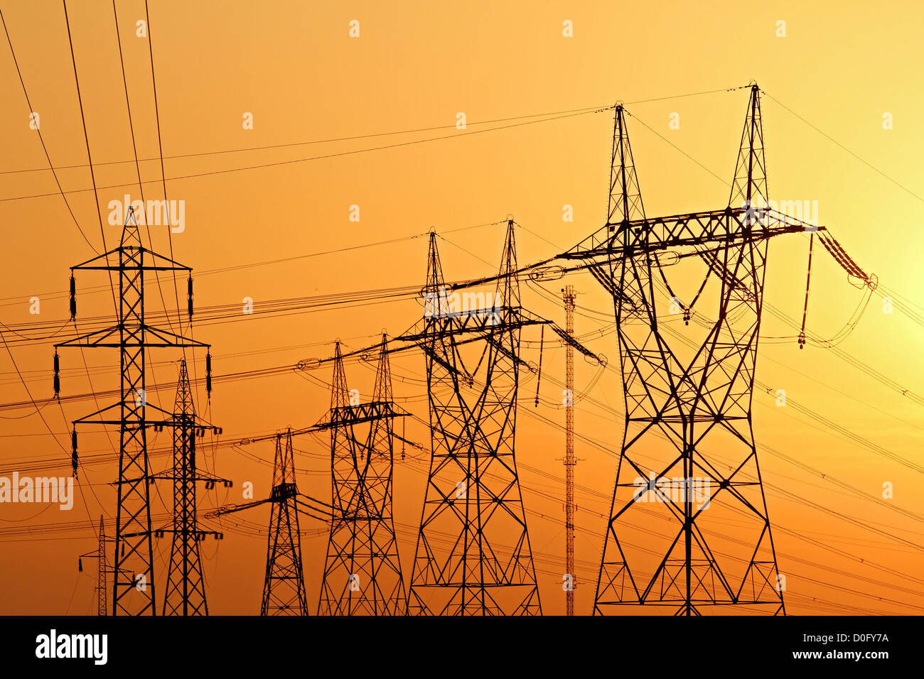 high voltage electrical pylons during sunset Stock Photo - Alamy