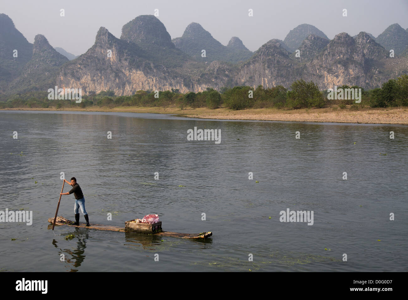 China Guangxi, Li River man on raft Stock Photo - Alamy