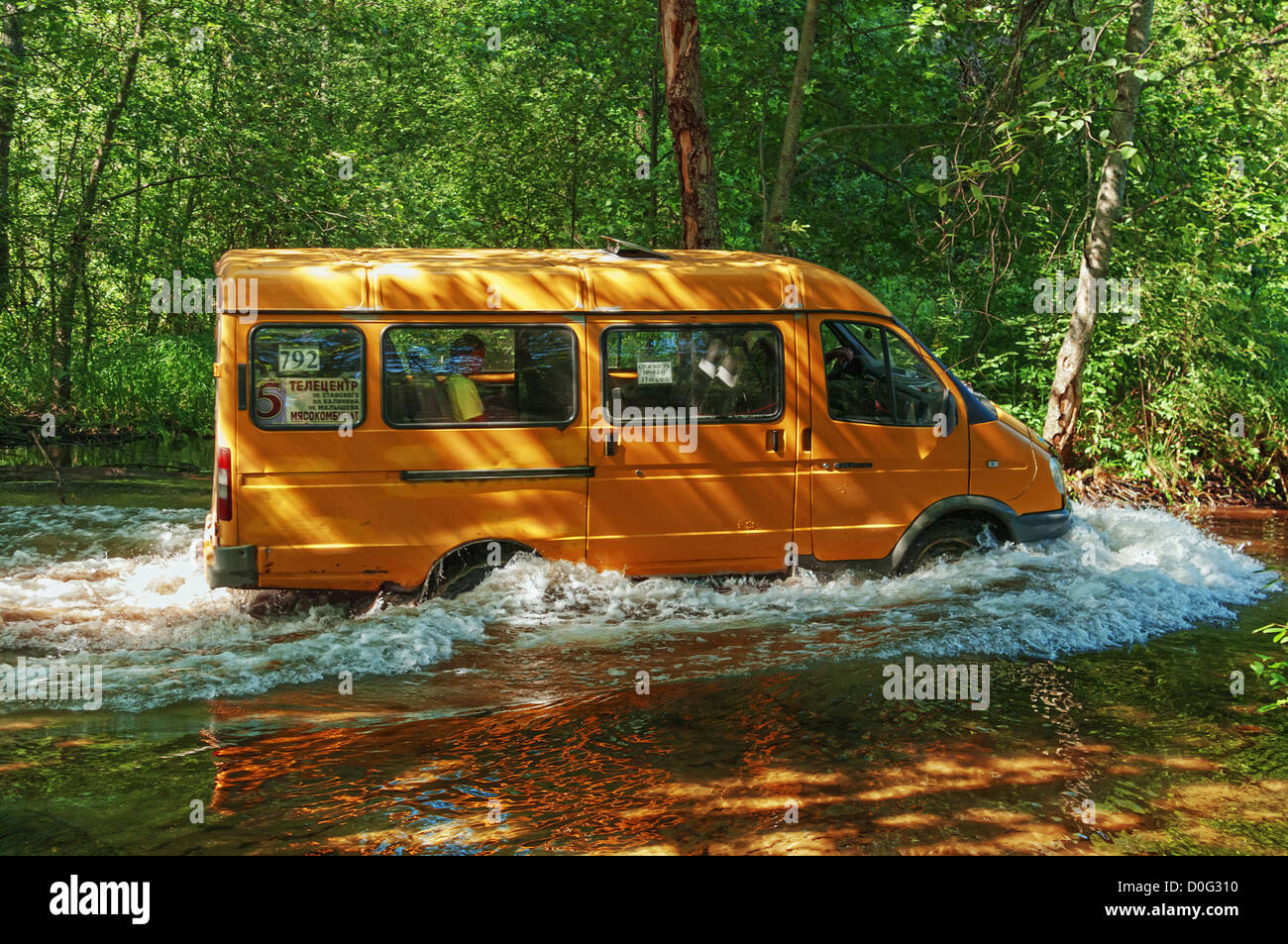 Yellow minibus fording small river Stock Photo - Alamy