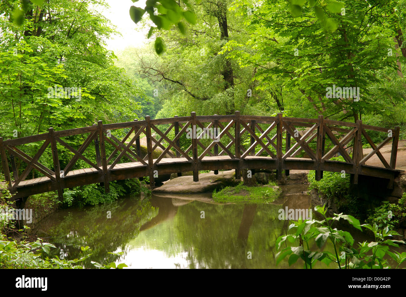 Beautiful wooden bridge in the summer park Stock Photo - Alamy
