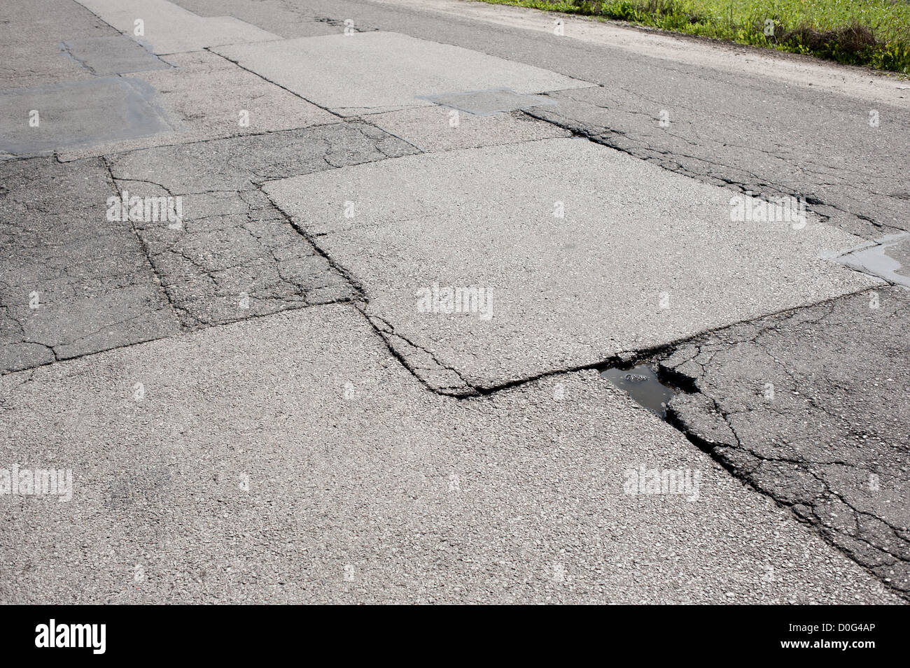 poor fixed chuckholes in asphalt damaged road Stock Photo - Alamy
