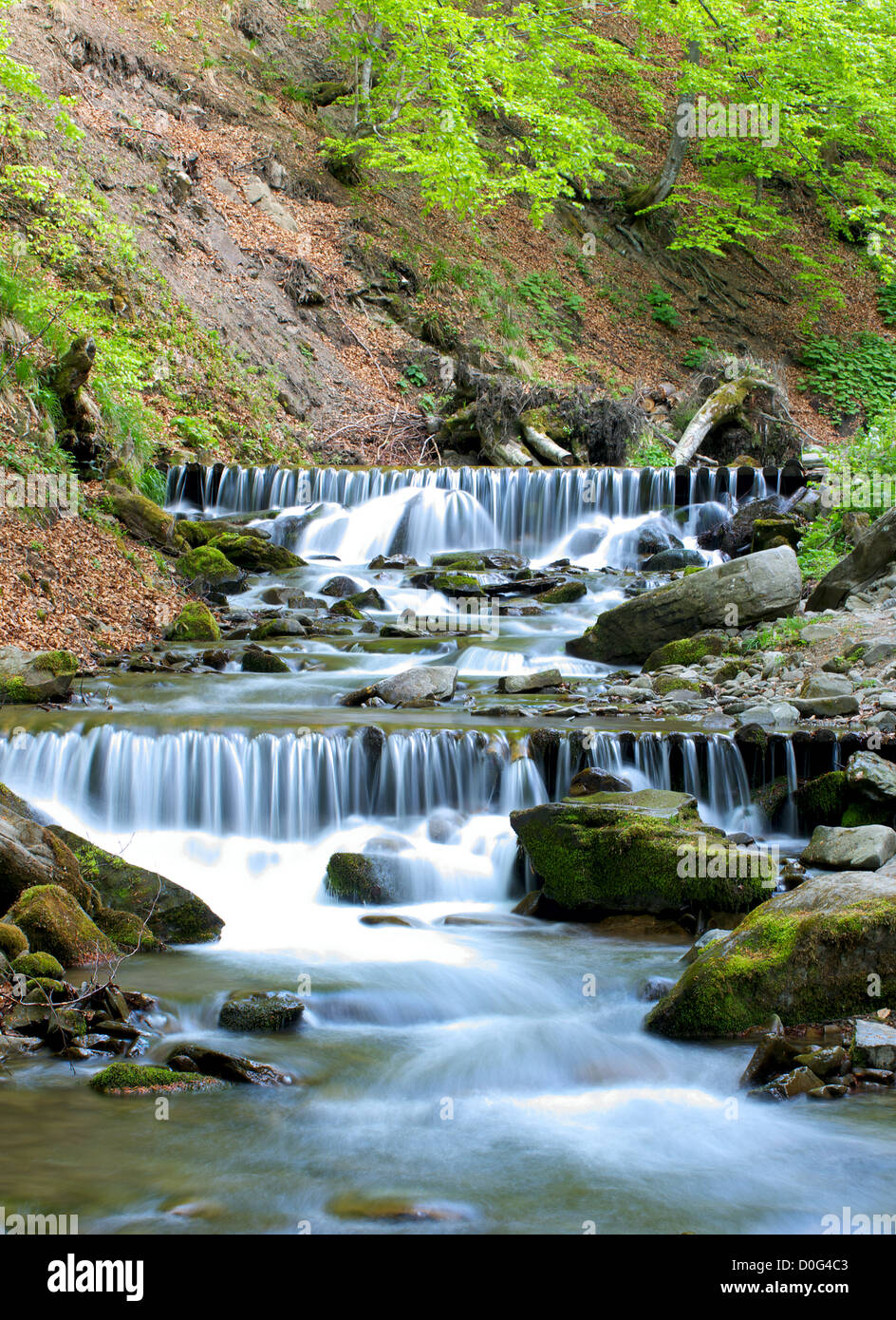 Beautiful waterfall cascades in the mountain forest Stock Photo - Alamy