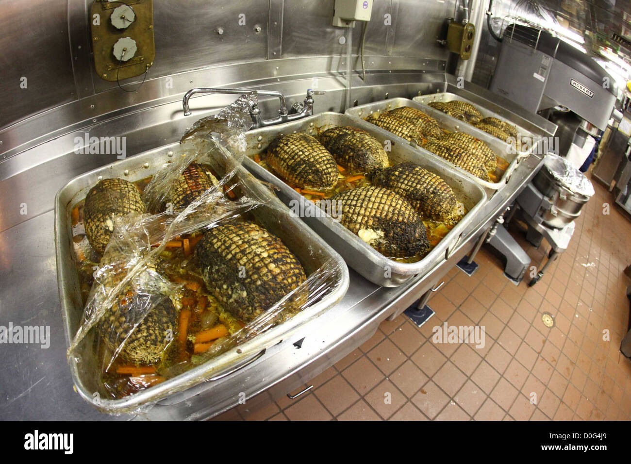 Serving pans of roasted turkey lie waiting for a Thanksgiving Day meal ...