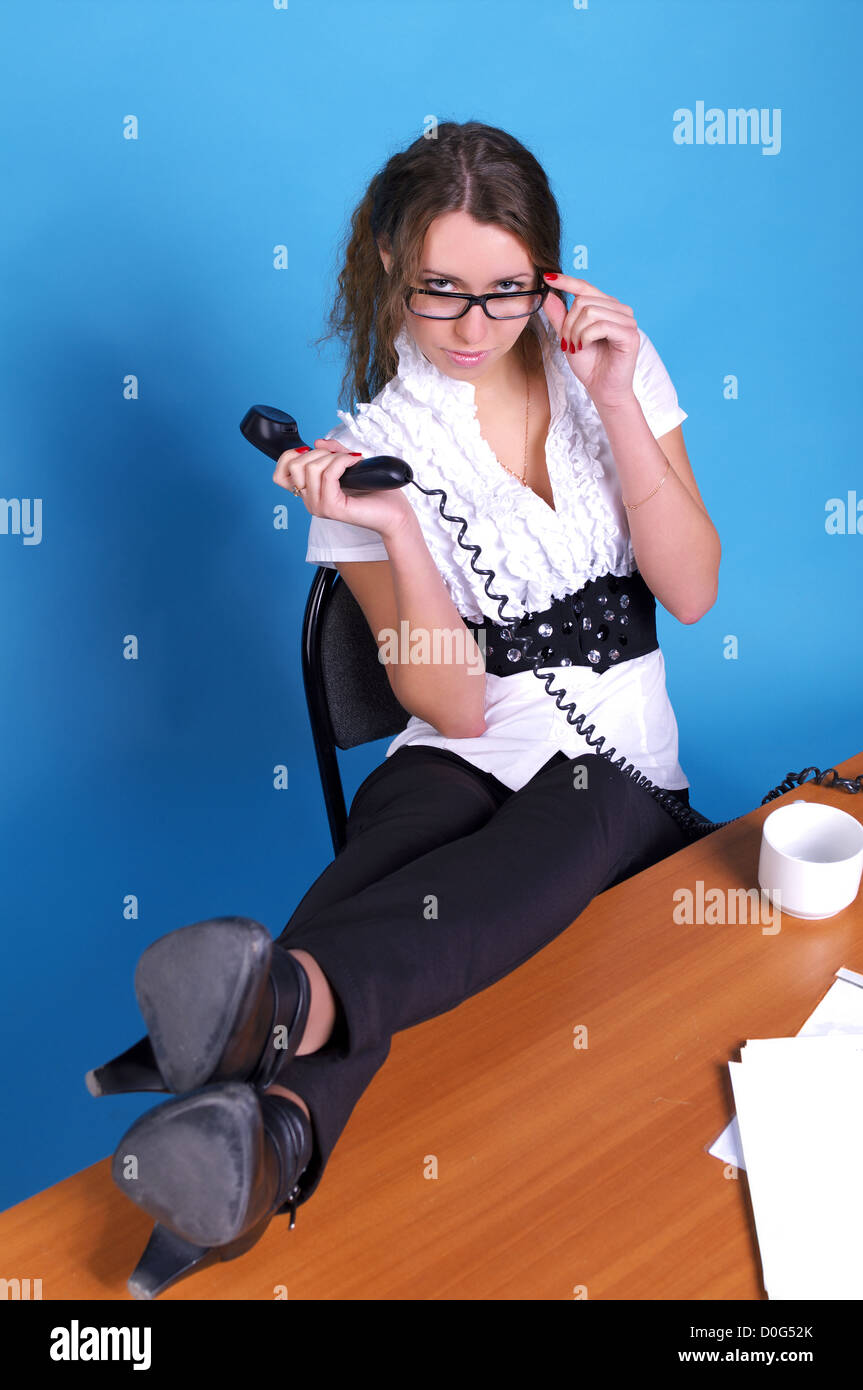 Young woman on desk legs glasses hi-res stock photography and images ...