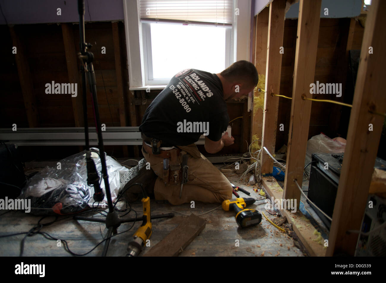 Electricians installing a heat register as part of the FEMA STEP ...