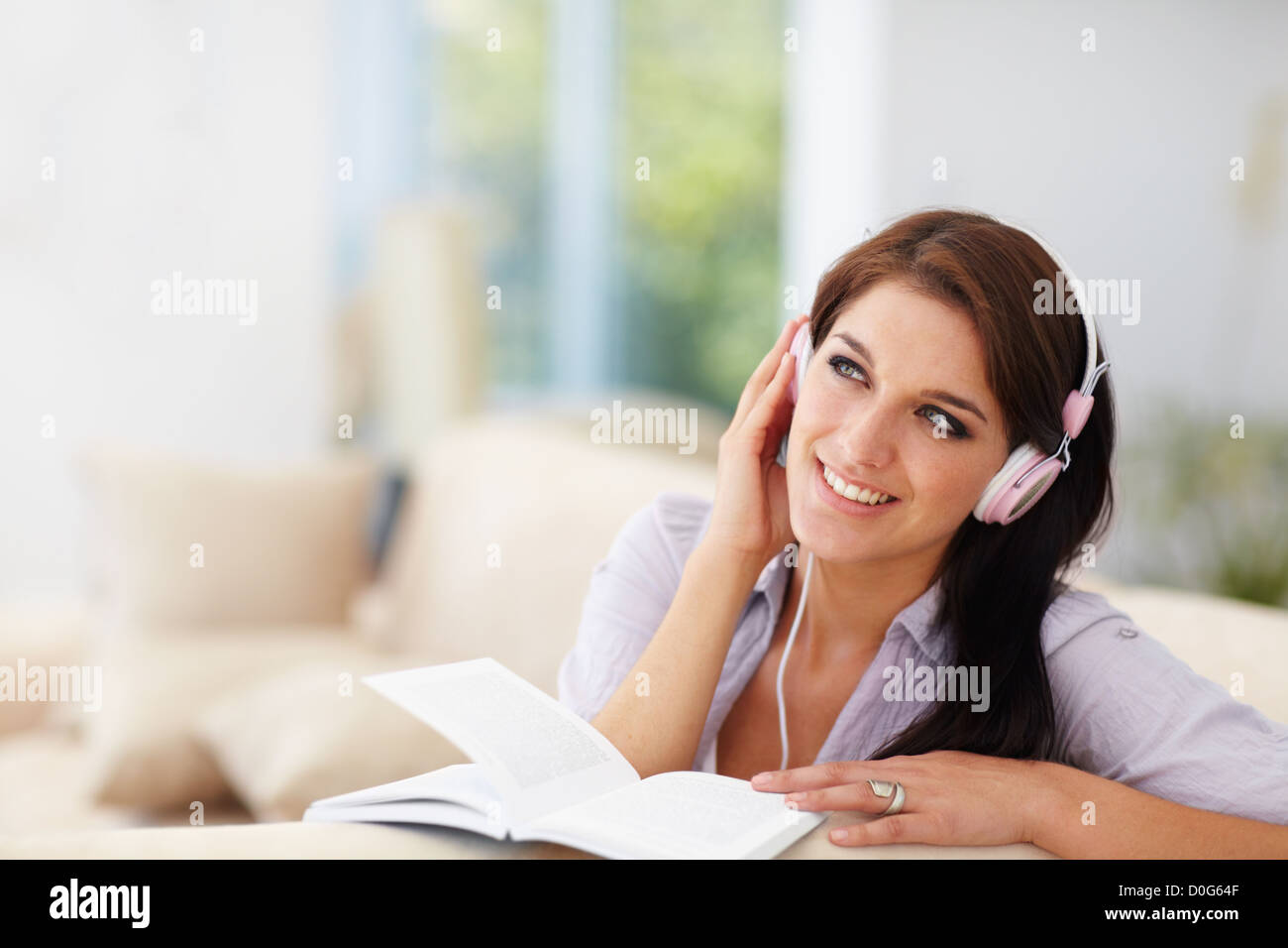Woman alone music listening headphones relaxed smile hi-res stock ...