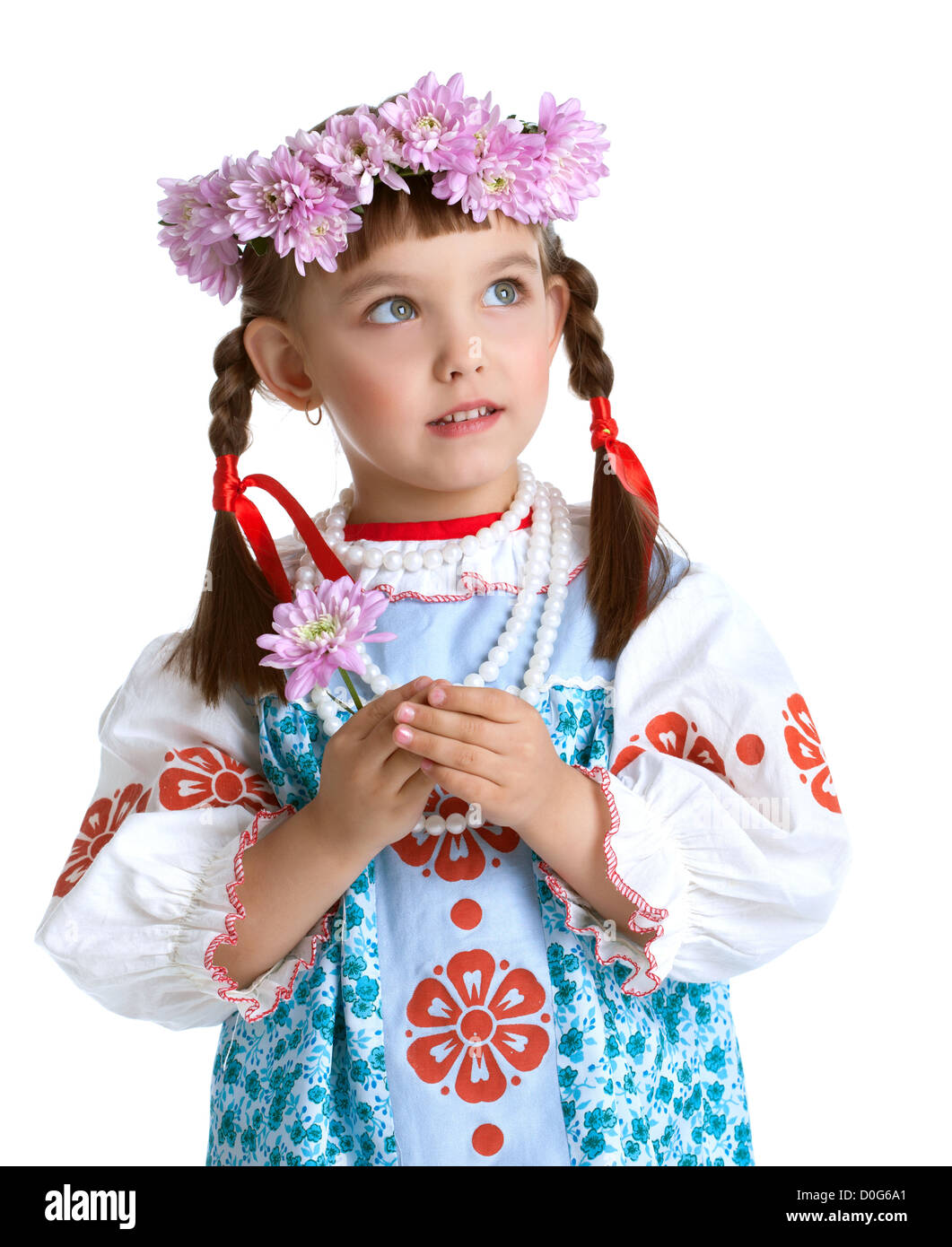 Portrait of cute little girl in slavic costume and wreath of flowers ...