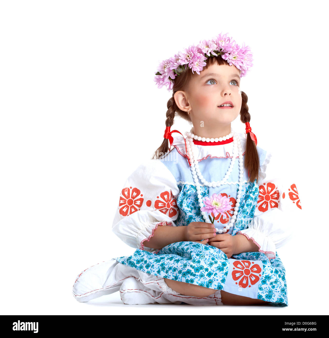Full length portrait of little girl in slavic costume and wreath of ...