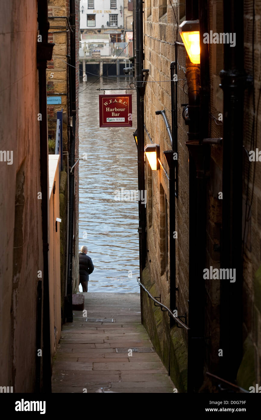 Alleyway down to harbour waterfront Whitby North Yorkshire Stock Photo ...
