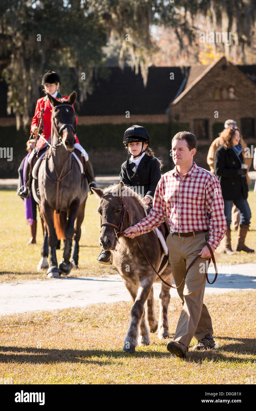 A young girl is escorted at the start of her first fox hunt at the ...