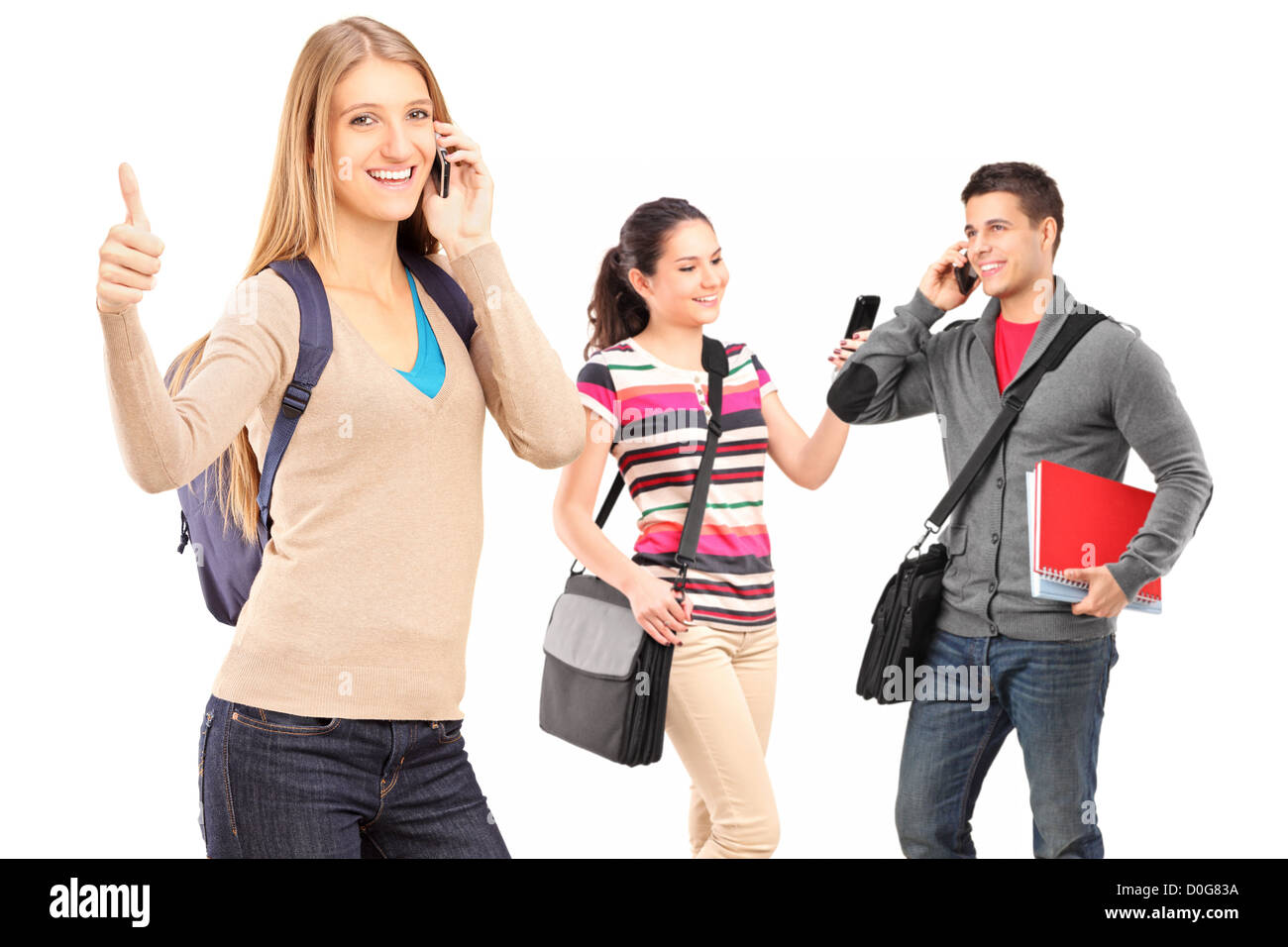 A happy male and female student using a mobile phones isolated on white ...