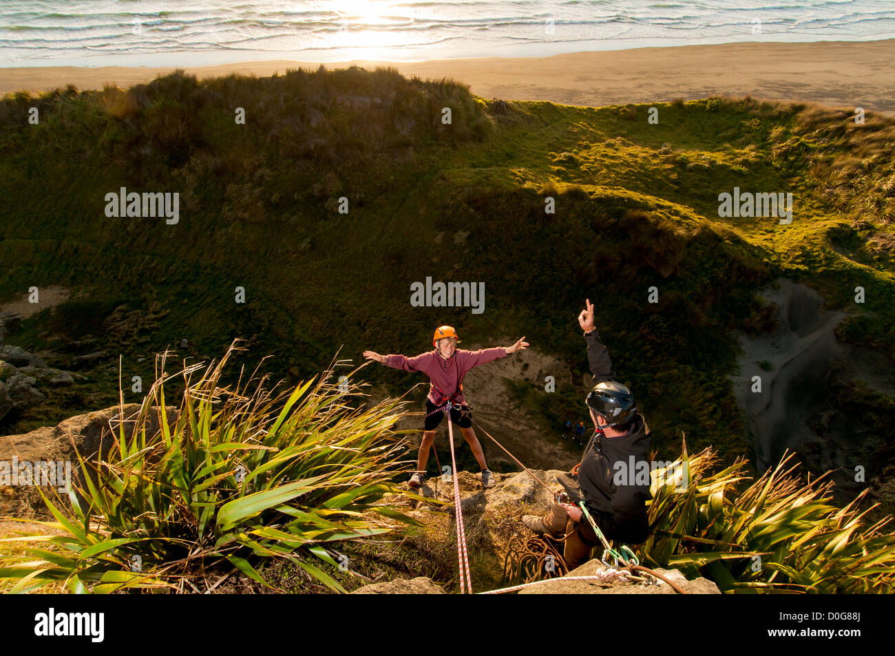 Young man abseiling down cliff hi-res stock photography and images - Alamy