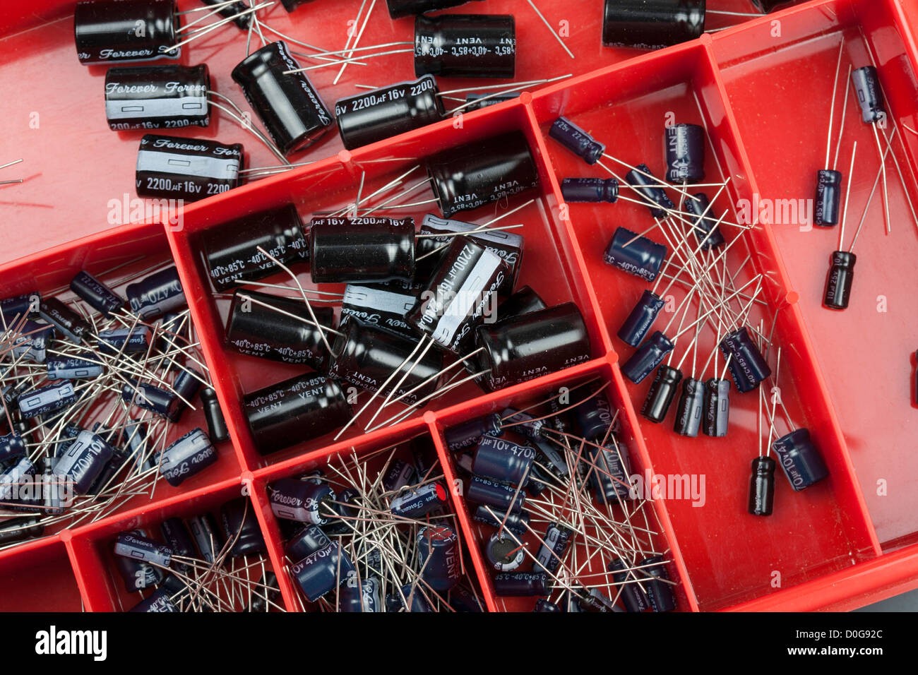 Close of capacitors in a red plastic box Boxed Electrical PCB component ...