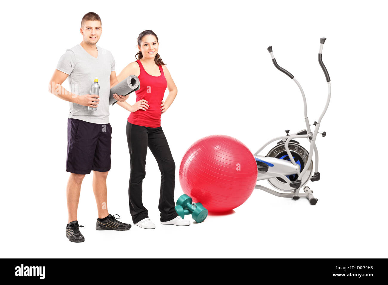 Full length portrait of a male and female athlete posing next to an ...