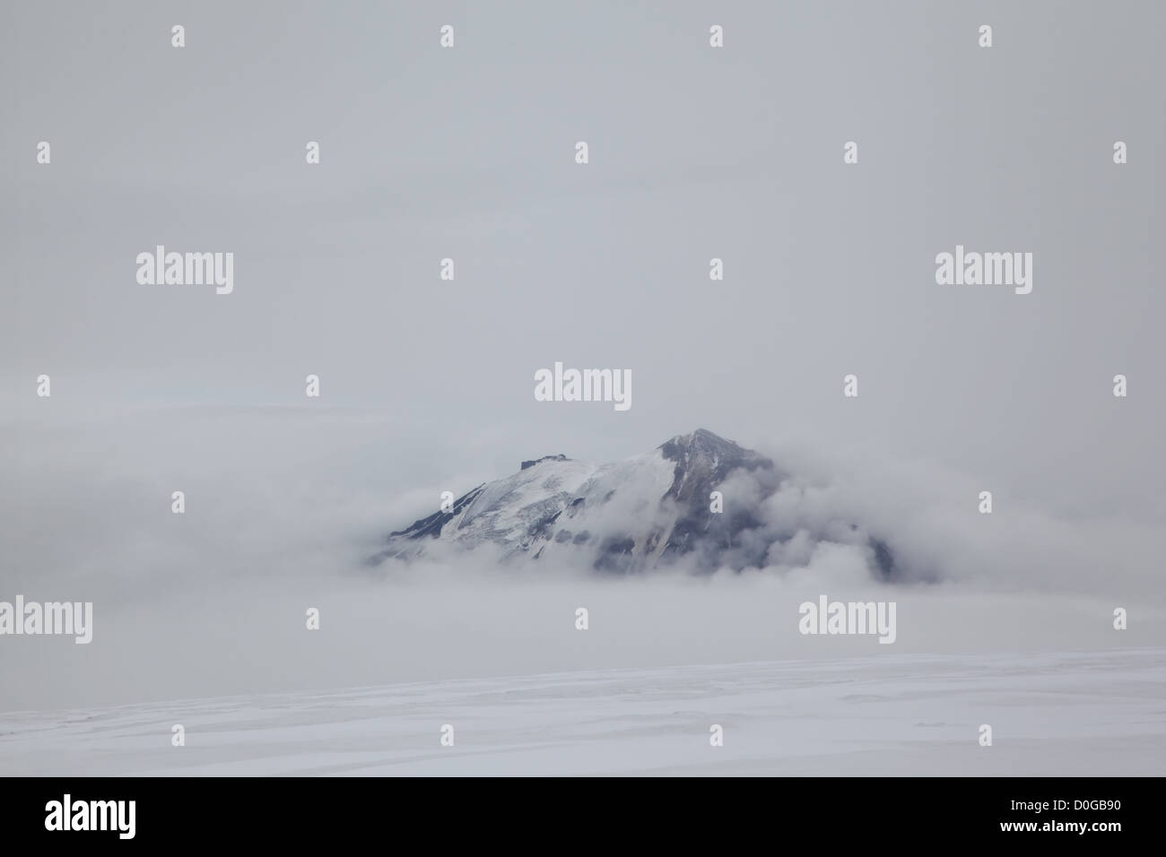 Klyuchevskoy nature park. Volcanoes of Kamchatka peninsula among clouds ...