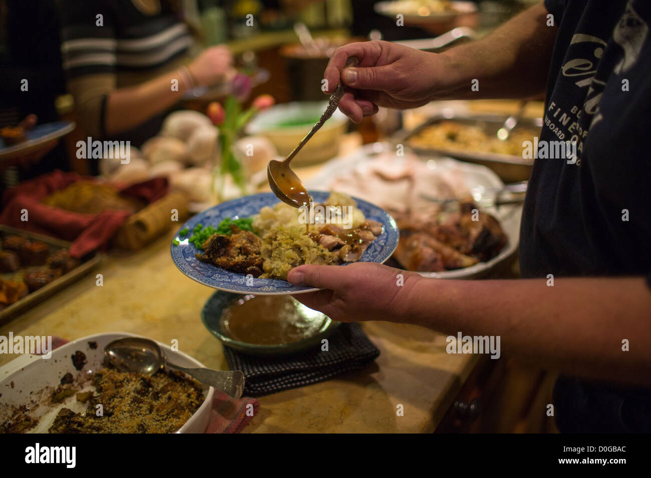 A family serves a traditional turkey meal during a Thanksgiving Day ...