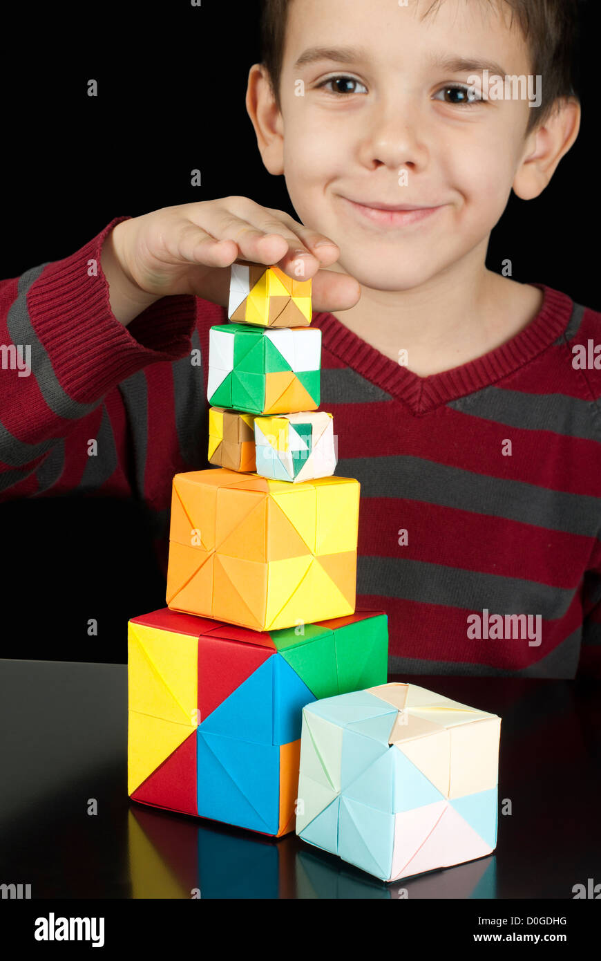 Little boy playing with multicolored cubes Stock Photo - Alamy