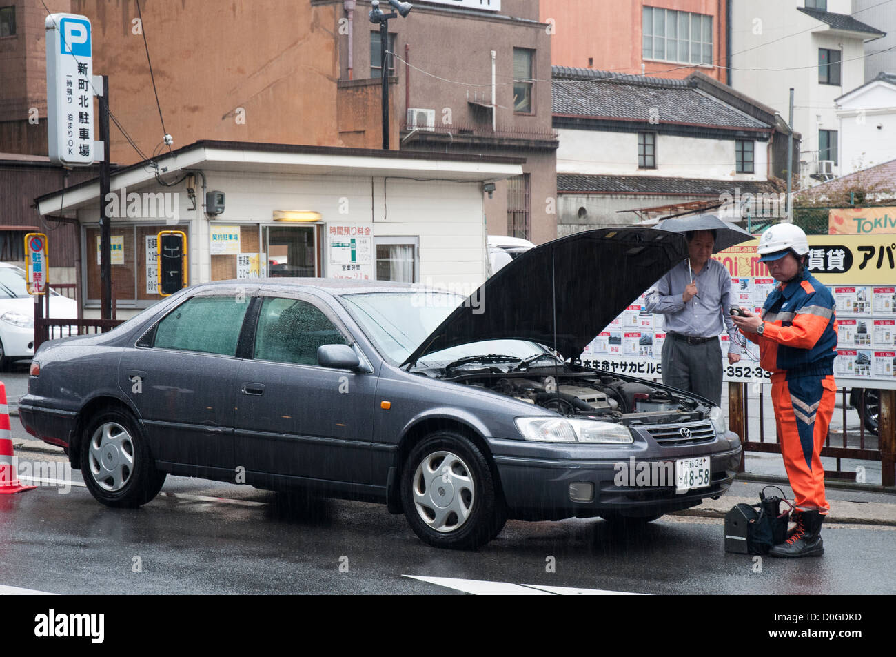 A motorist receives roadside breakdown service from a Japanese ...