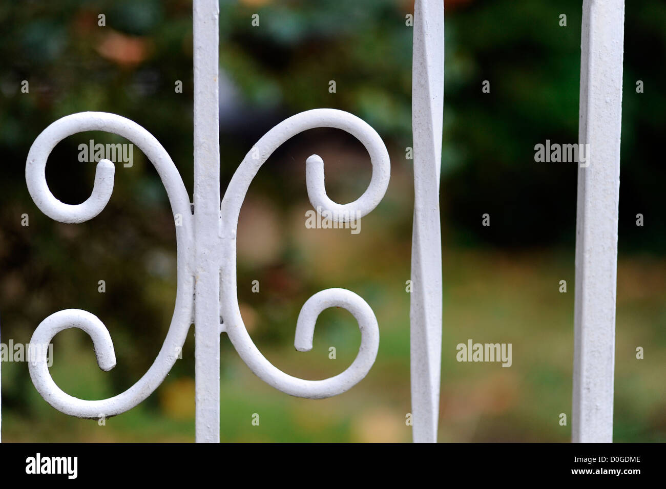 Scroll detail of wrought iron fence painted white Stock Photo - Alamy