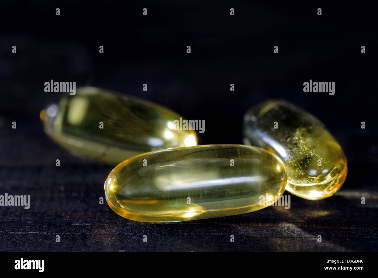 Omega 3 fish fat oil pills on black background Stock Photo - Alamy
