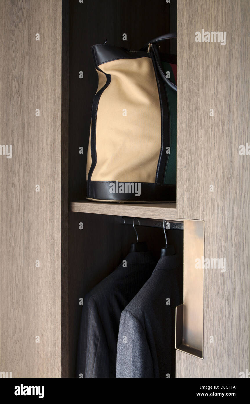 Open wardrobe with clothes, suits, and luggage Stock Photo - Alamy