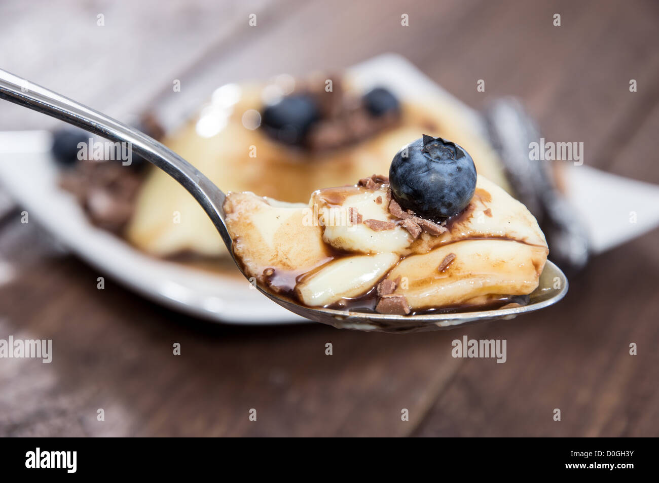 Vanilla Pudding with chocolate sauce on a spoon Stock Photo - Alamy