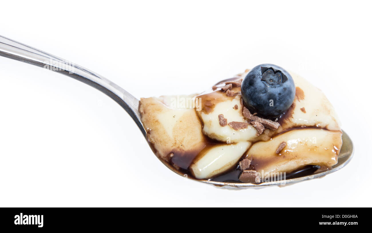 Vanilla Pudding on a spoon against white background Stock Photo - Alamy