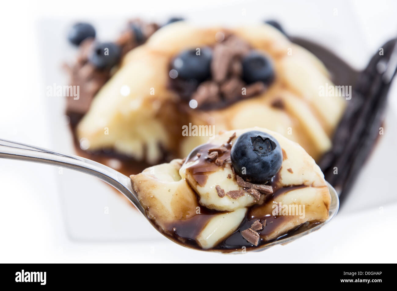 Vanilla Pudding on a spoon against white background Stock Photo - Alamy