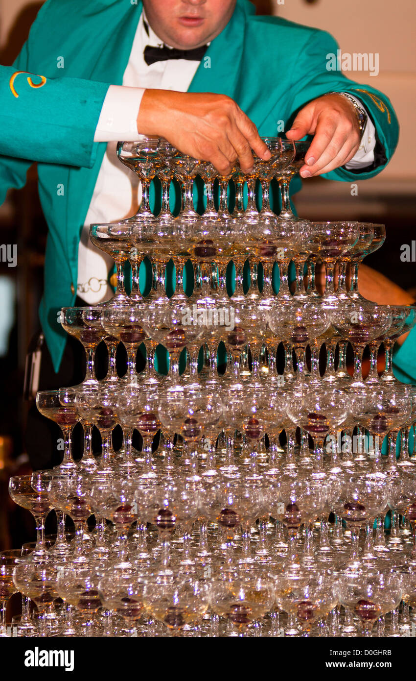 Assembling champagne glasses for a champagne waterfall on a cruise ship ...