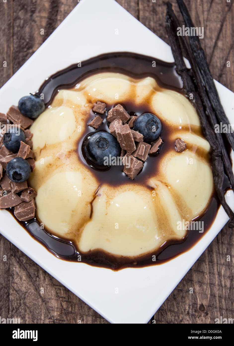 Portion of Vanilla Pudding with chocolate sauce Stock Photo - Alamy
