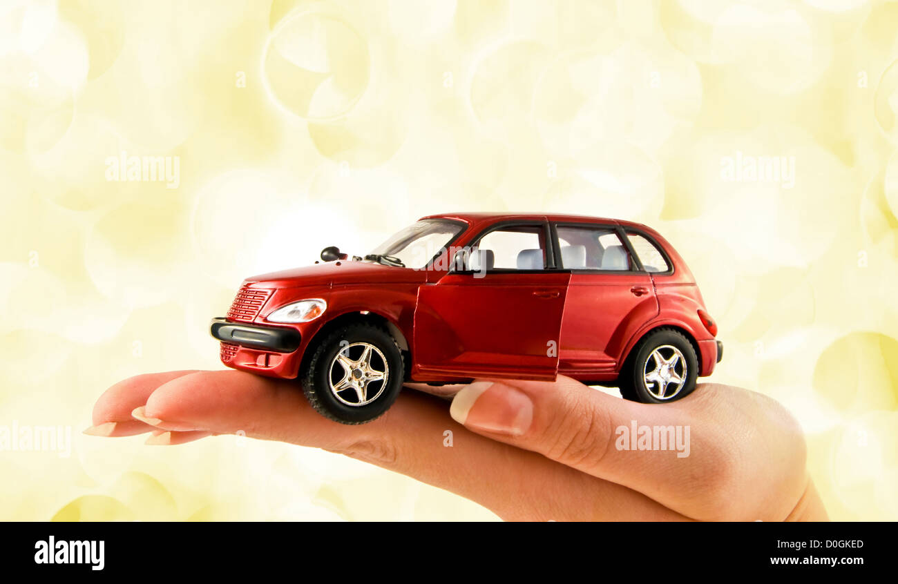 Red car in hand Stock Photo - Alamy