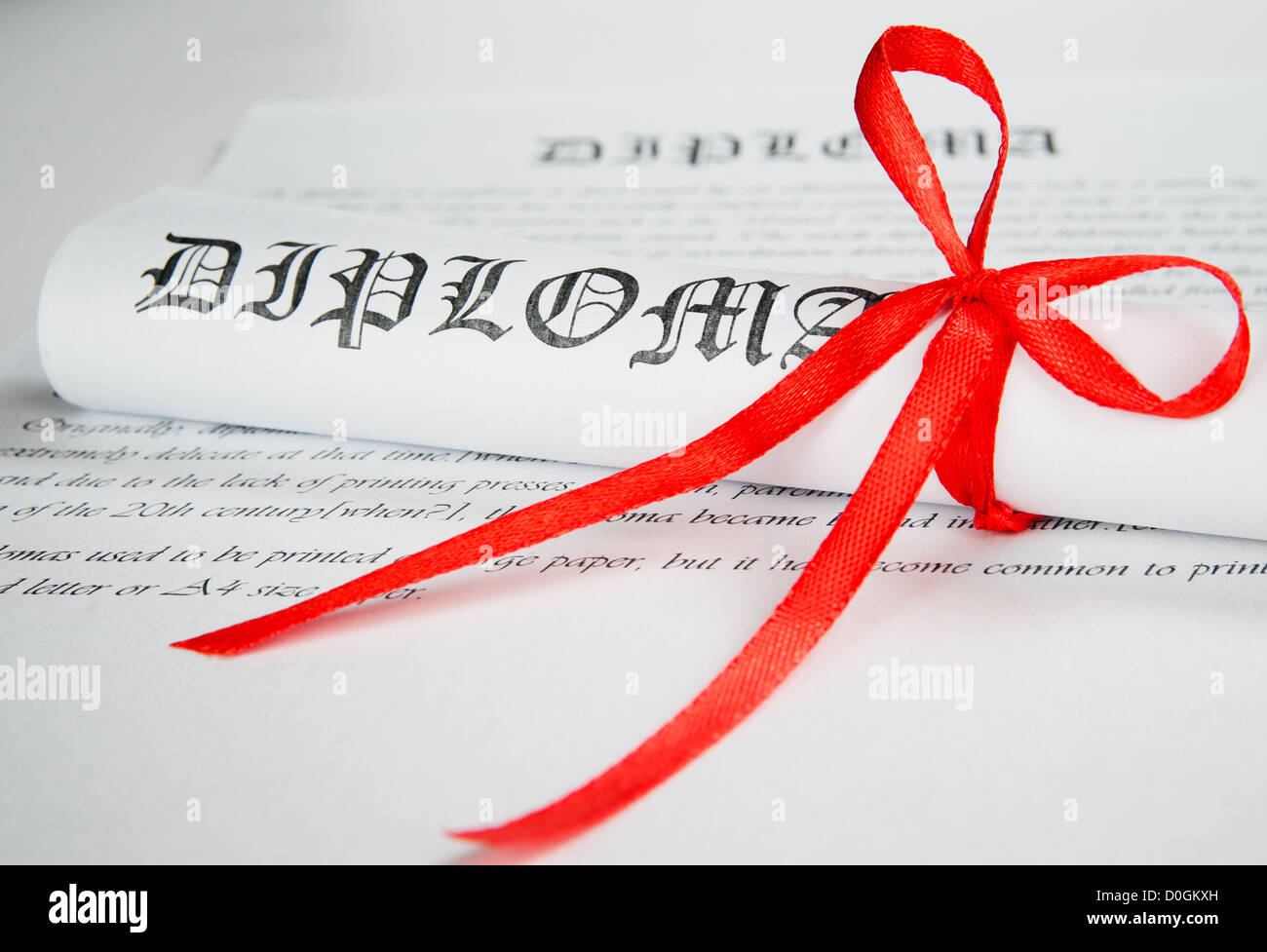 Diploma with red ribbon Stock Photo - Alamy
