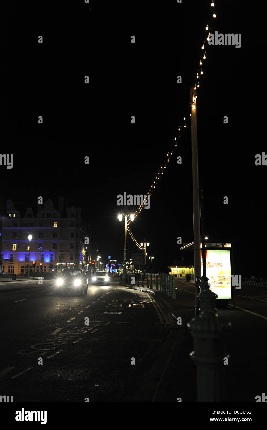 Traffic headlights on Brighton seafront at night with lights strung out ...
