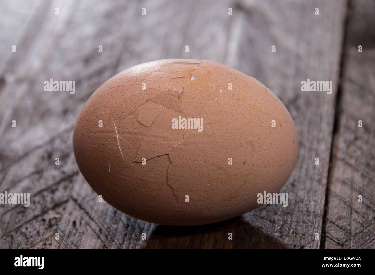 Cracked egg on wooden background Stock Photo - Alamy