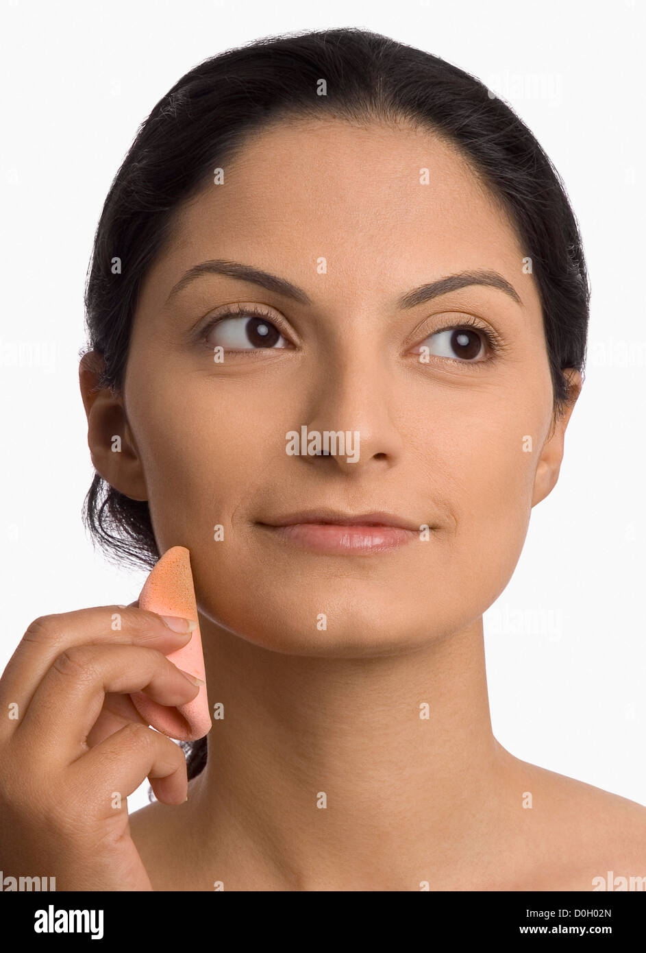 Person's hand applying powder puff on a young woman's face Stock Photo ...