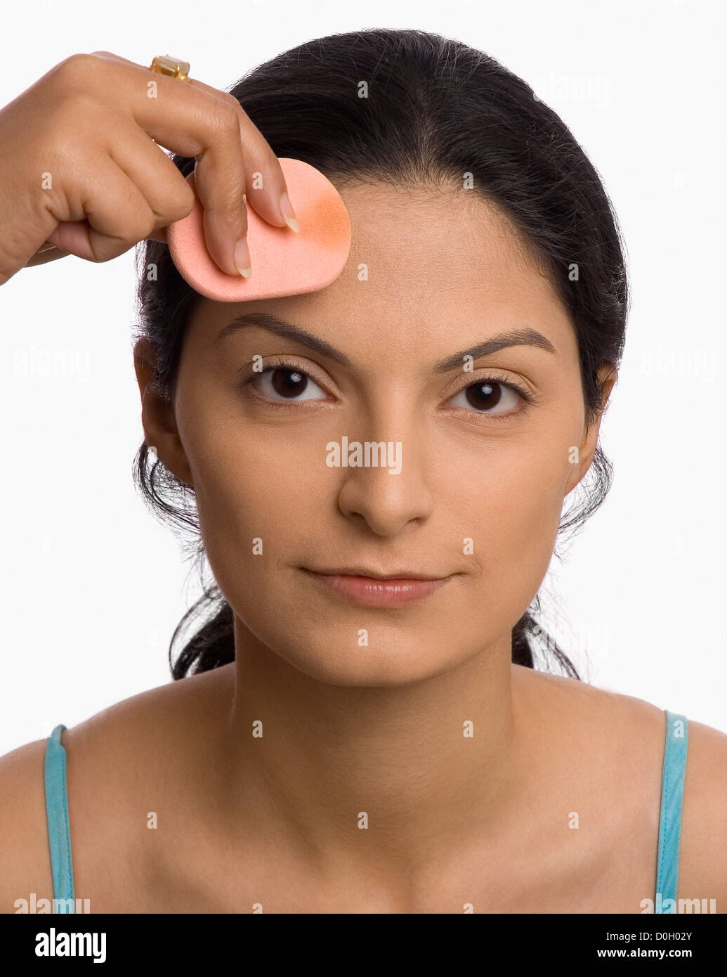 Person's hand applying powder puff on a young woman's face Stock Photo ...