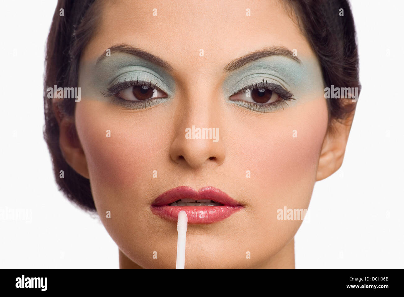 Female fashion model applying lipstick Stock Photo - Alamy