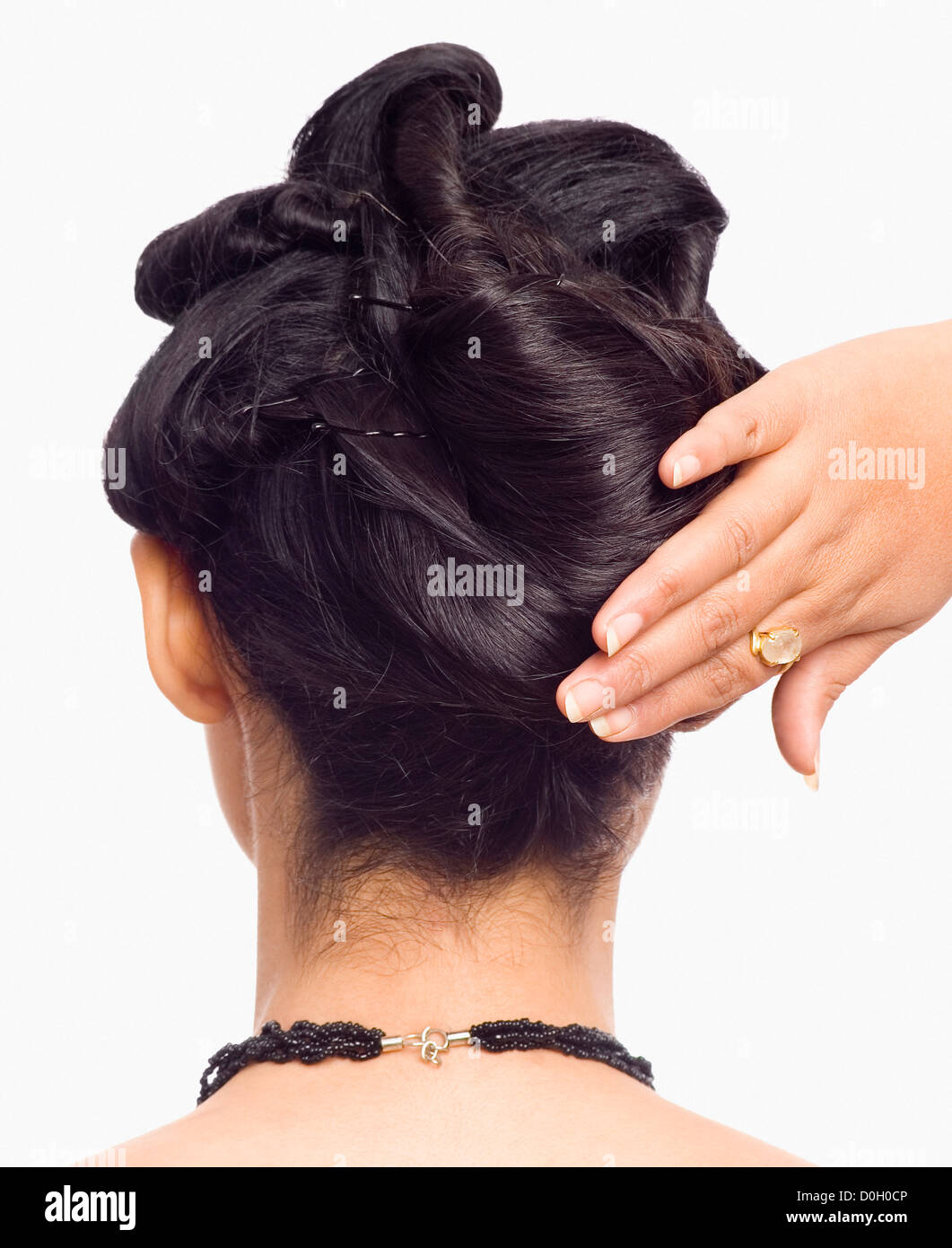 Person's hand styling a young woman's hair Stock Photo - Alamy